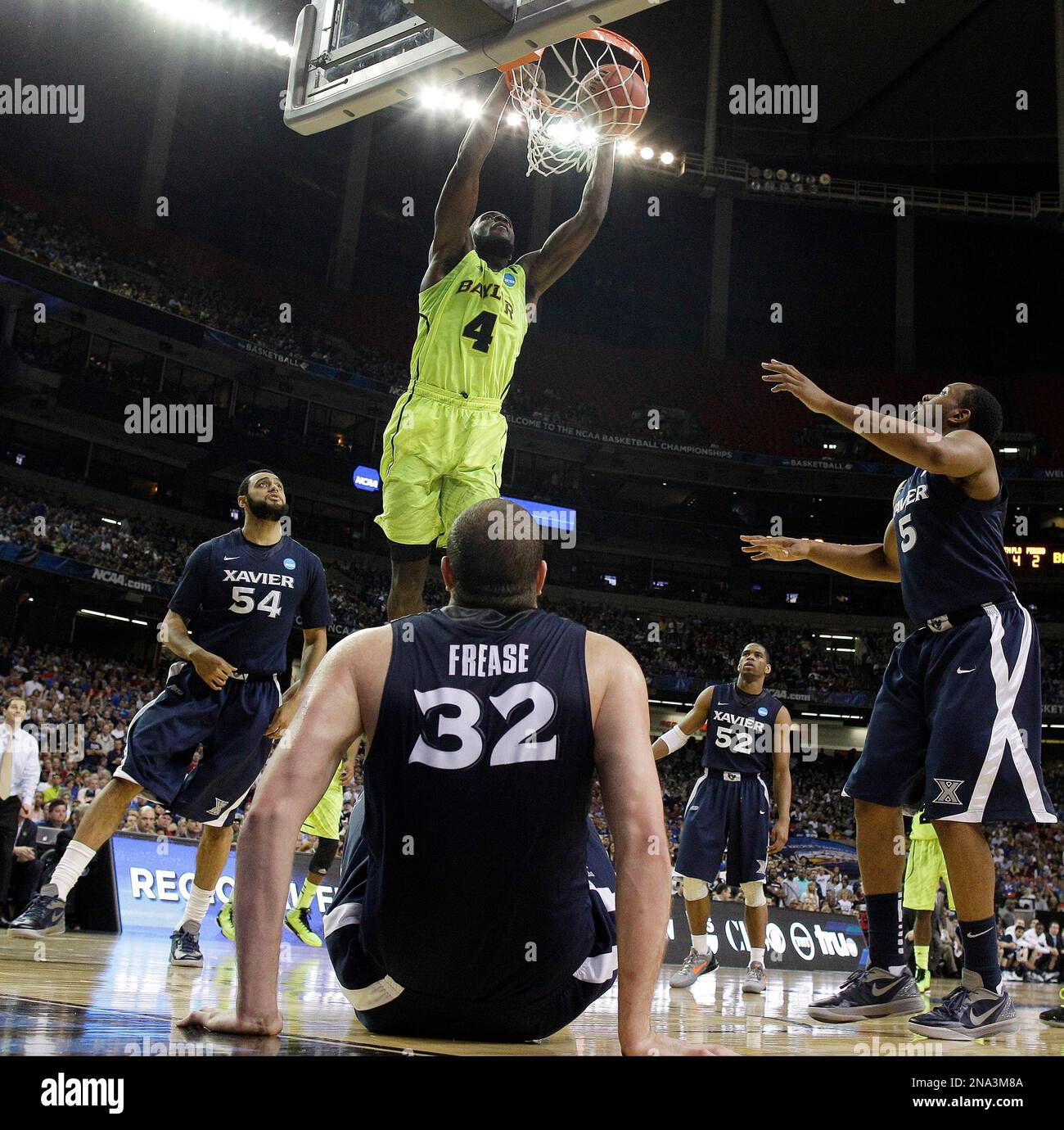 Baylor's Quincy Acy (4) dunks the ball as Xavier's Kenny Frease (32 ...