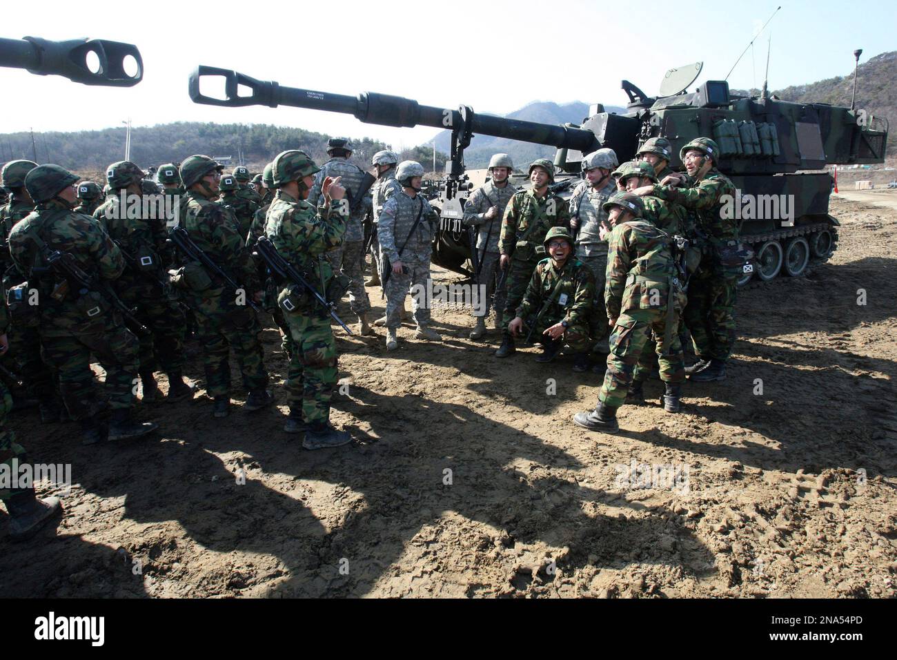South Korean and U.S. army soldiers, gray, pose after a live fire drill ...