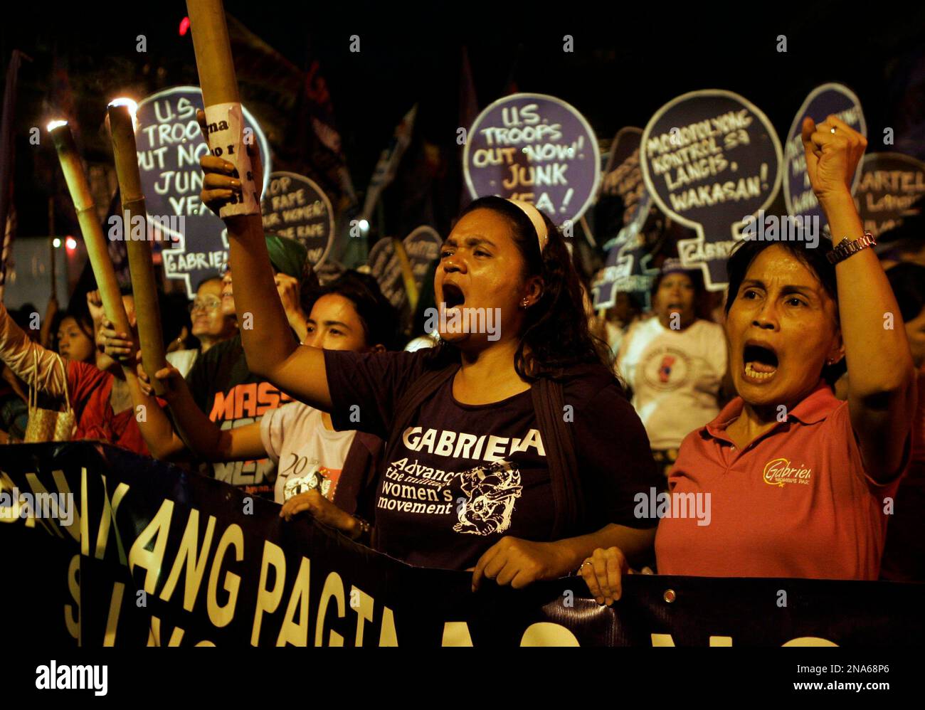 Female protesters raise their clenched fists as they shout slogans ...