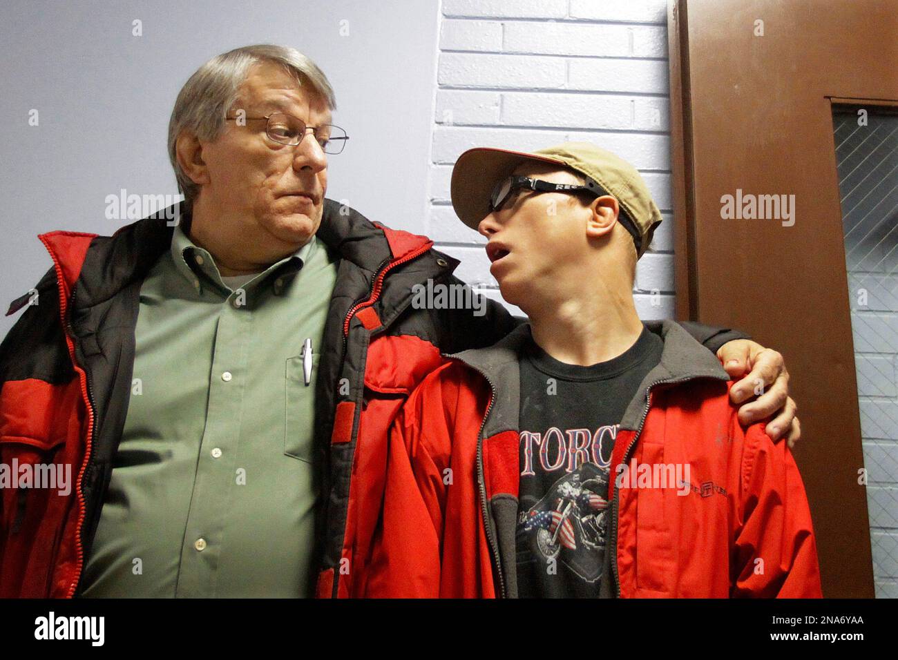 David Iacono-Harris, left, hugs his son, Jonathan, at the Jacksonville ...
