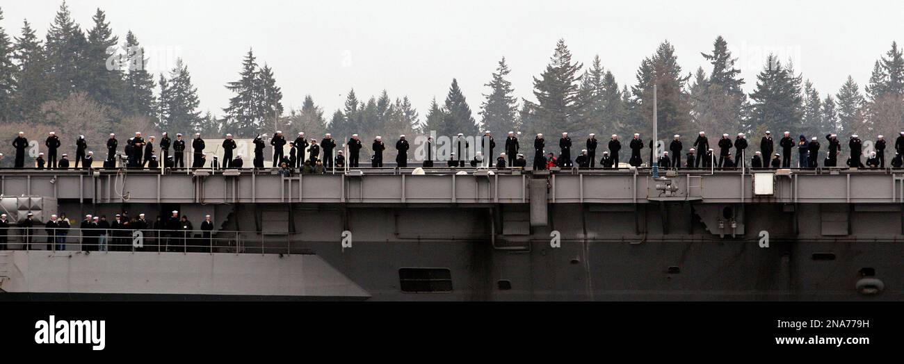 Sailors line the deck on the return of the USS Stennis to Naval Base ...