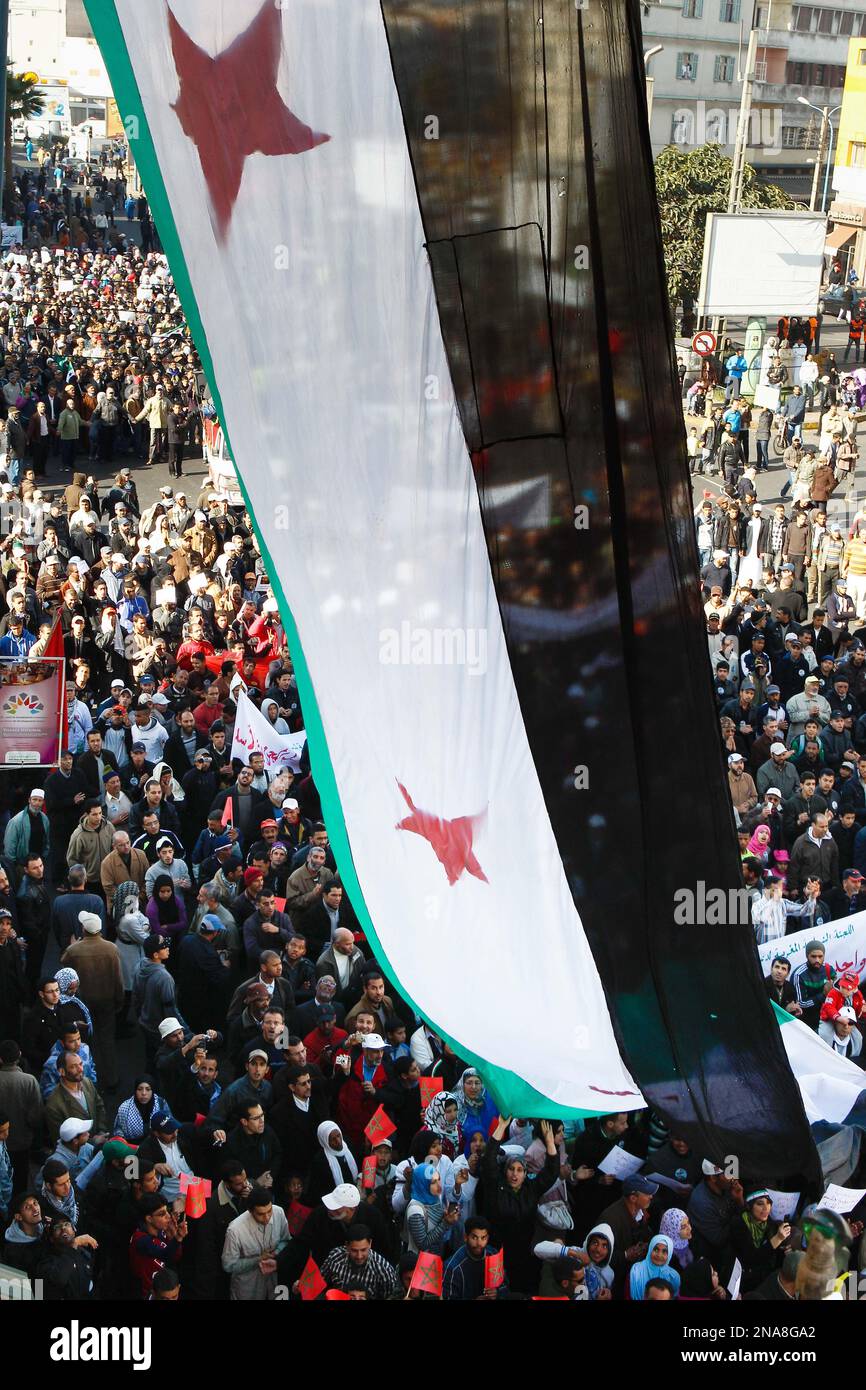 A big Syrian flag is displayed from house as Moroccans and Syrian ...