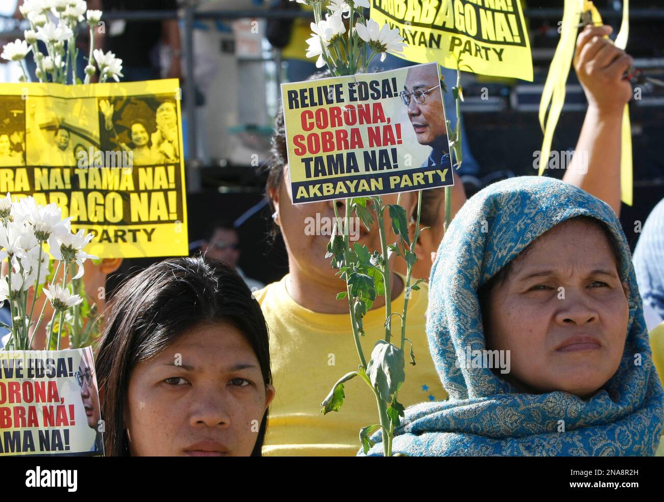 A small group of protesters display messages against Philippine Supreme ...
