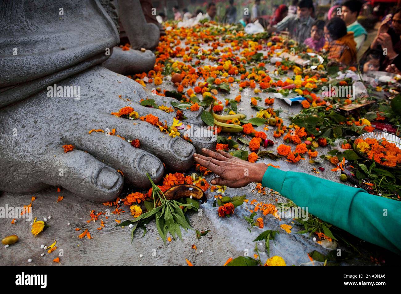 An Indian Hindu devotee touches the foot of a statue of Lord Ram as he ...