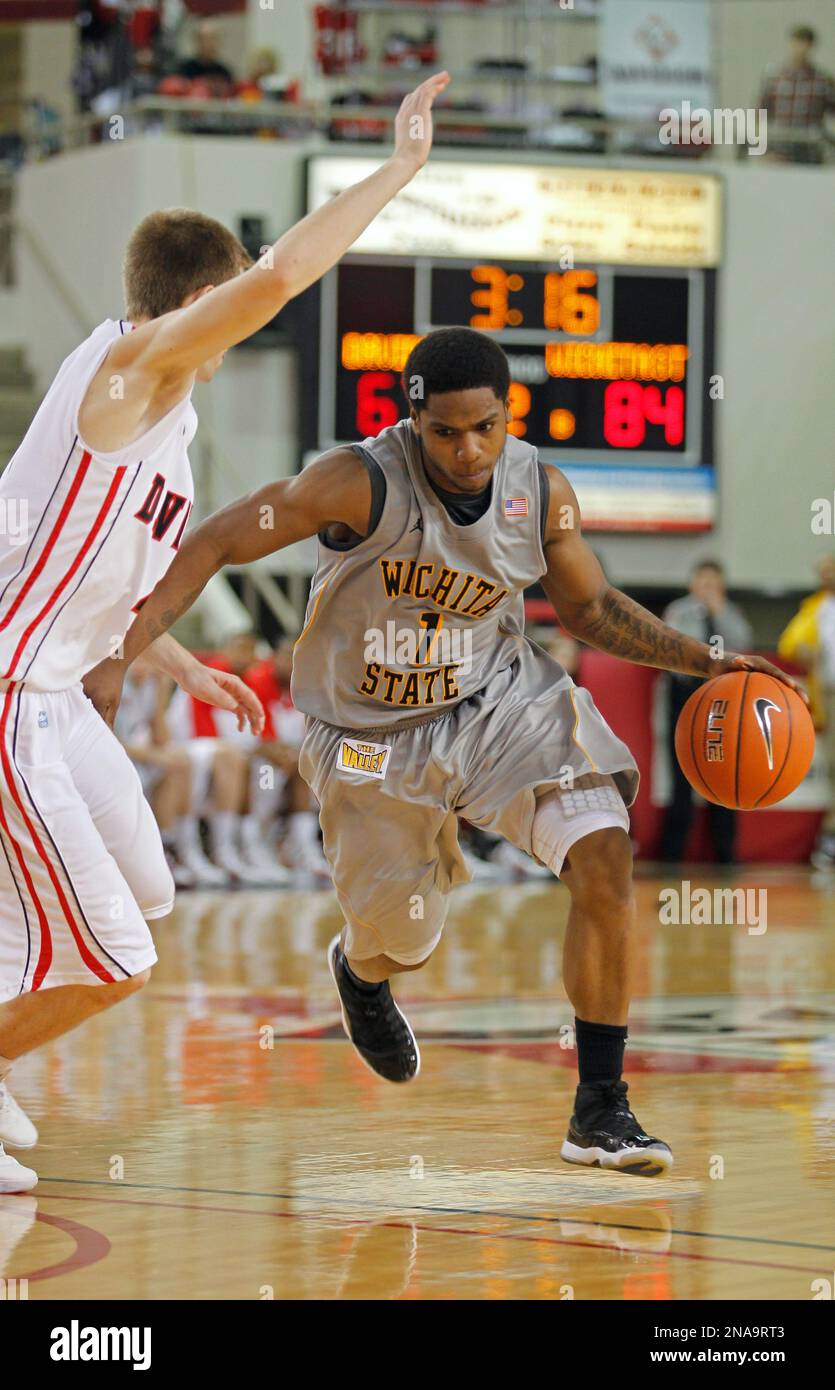 Wichita State 's Joe Ragland, right, puts head down and dribble past ...