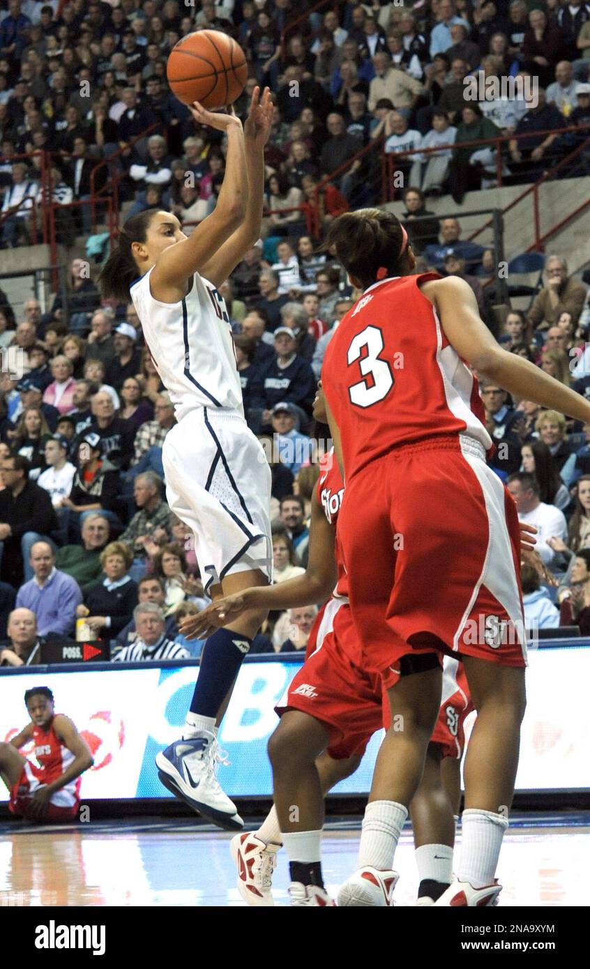 Connecticut's Bria Hartley, left, goes up fro a shot as St. John's Da ...
