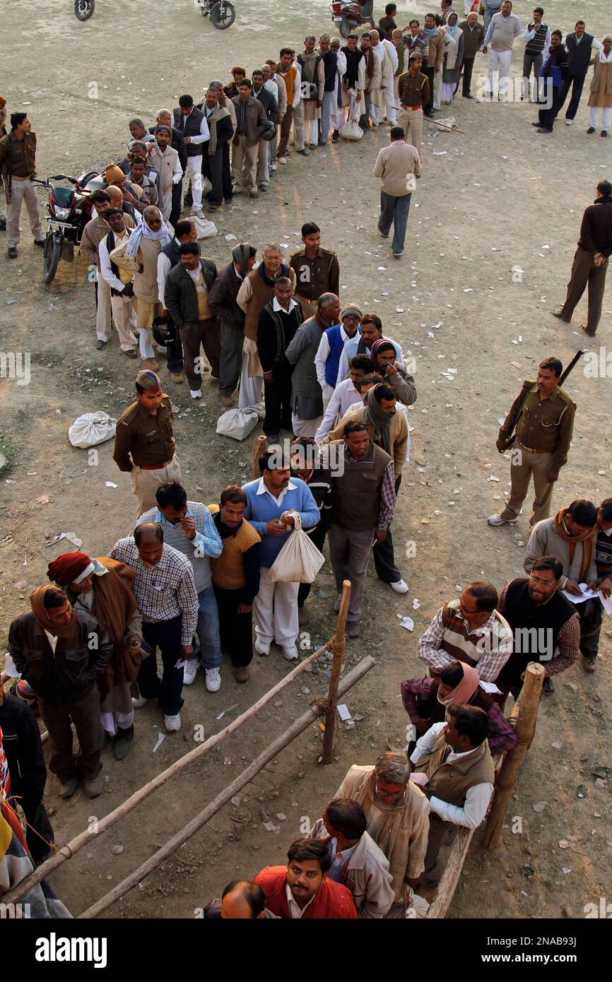 Government employees stand in a queue to cast their votes in advance, a ...