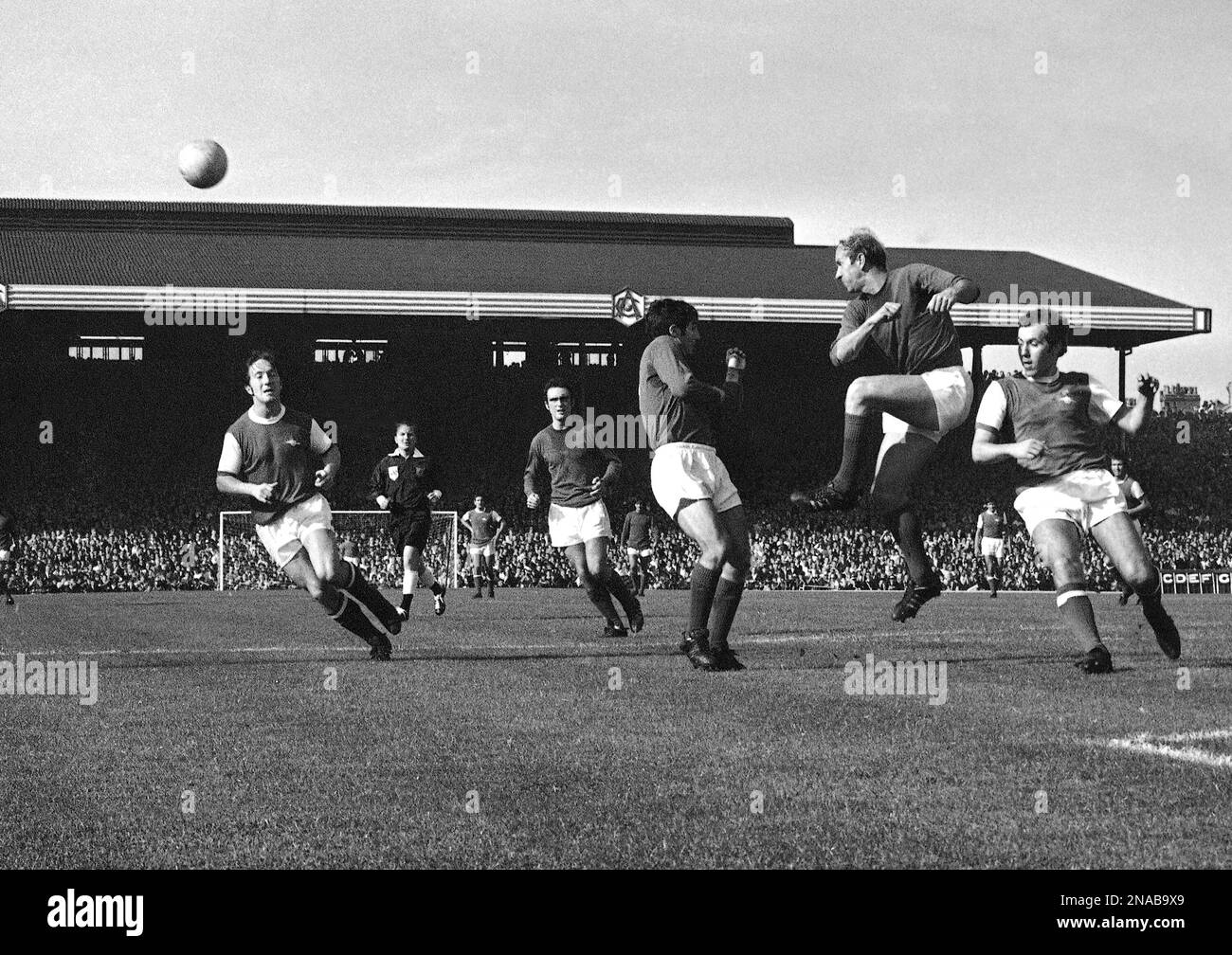 Manchester United's Bobby Charlton, second from right, kicks the ball ...