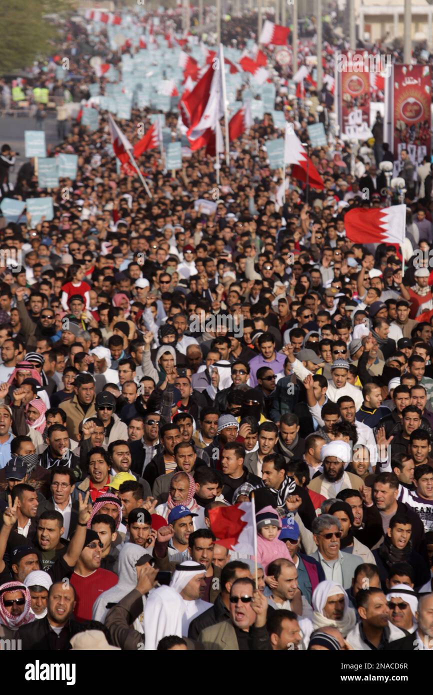 Anti-government protesters wave Bahraini flags and chant anti ...