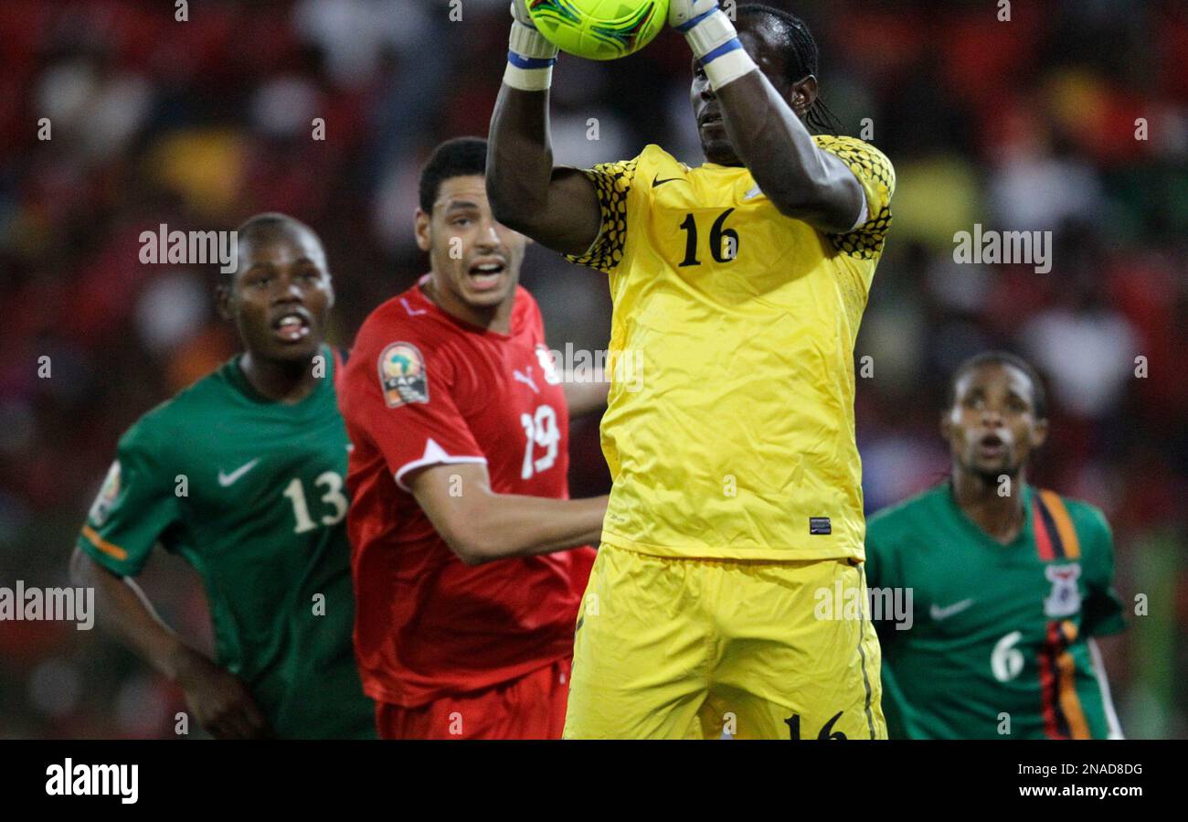 Zambia goalkeeper Kennedy Mweene, center, leaps to catch a loose ball ...