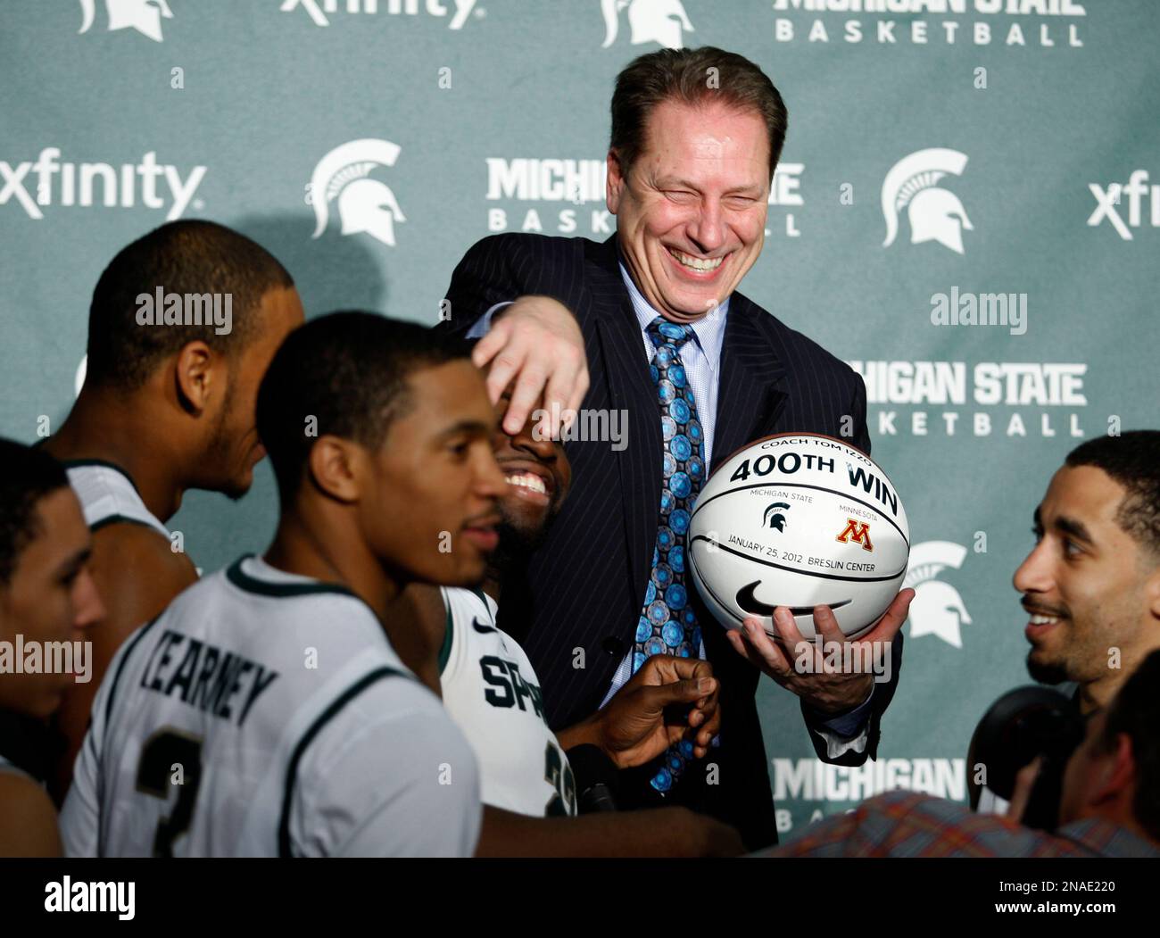 Michigan State coach Tom Izzo, top, smiles after his players barged ...