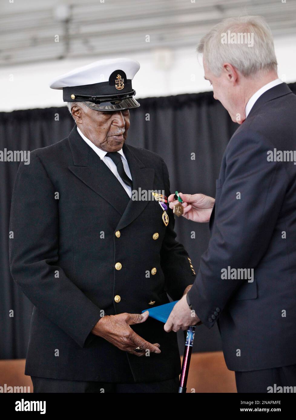 Carl Clark, 95, left, is presented the prestigious Navy and Marine ...