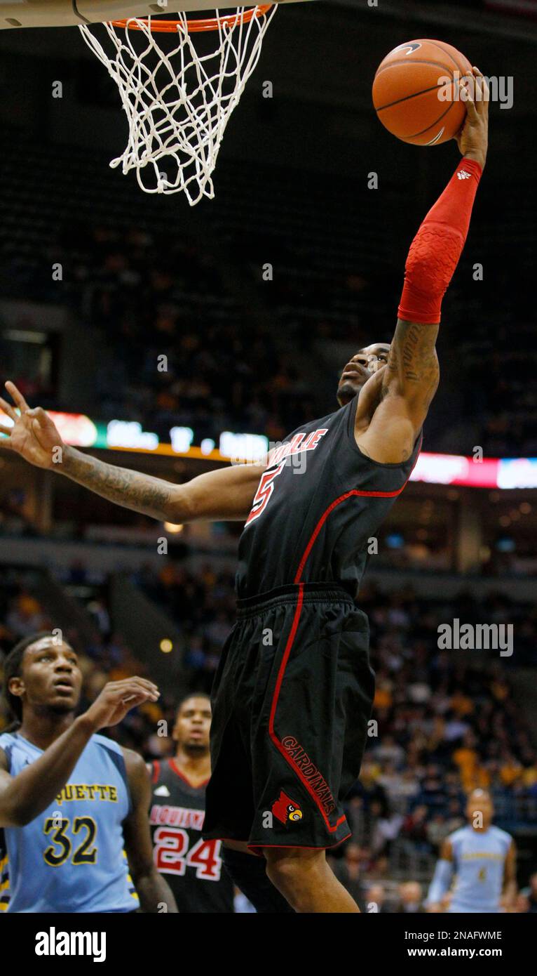 Louisville's Chris Smith (5) drives to the basket as Marquette's Jae ...