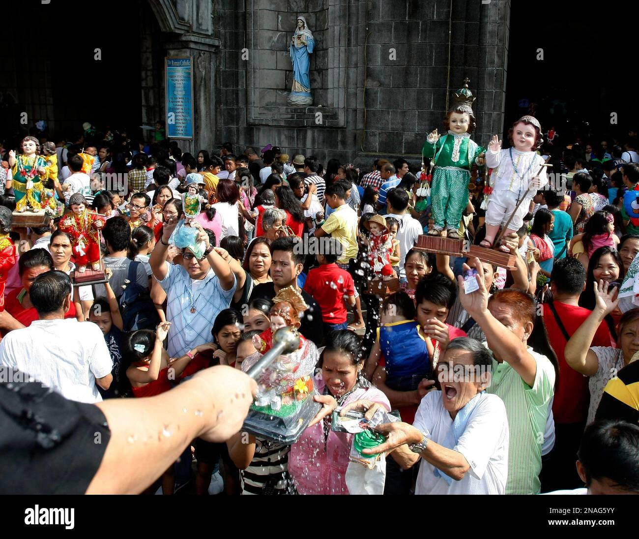 Roman Catholic devotees raise their Child Jesus statues as they are ...