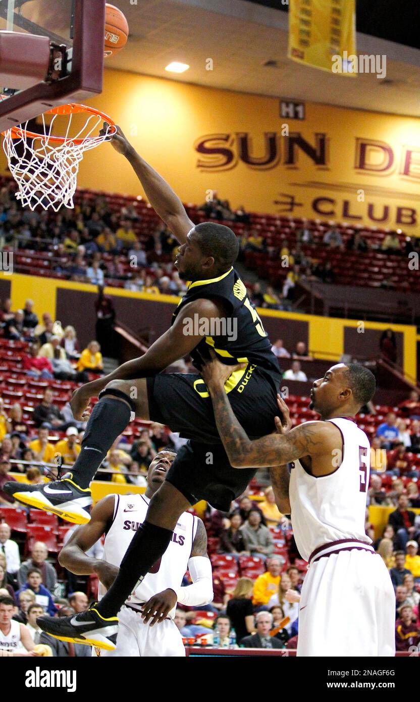 Oregon's Olu Ashaolu, center, misses a dunk as he gets past Arizona ...