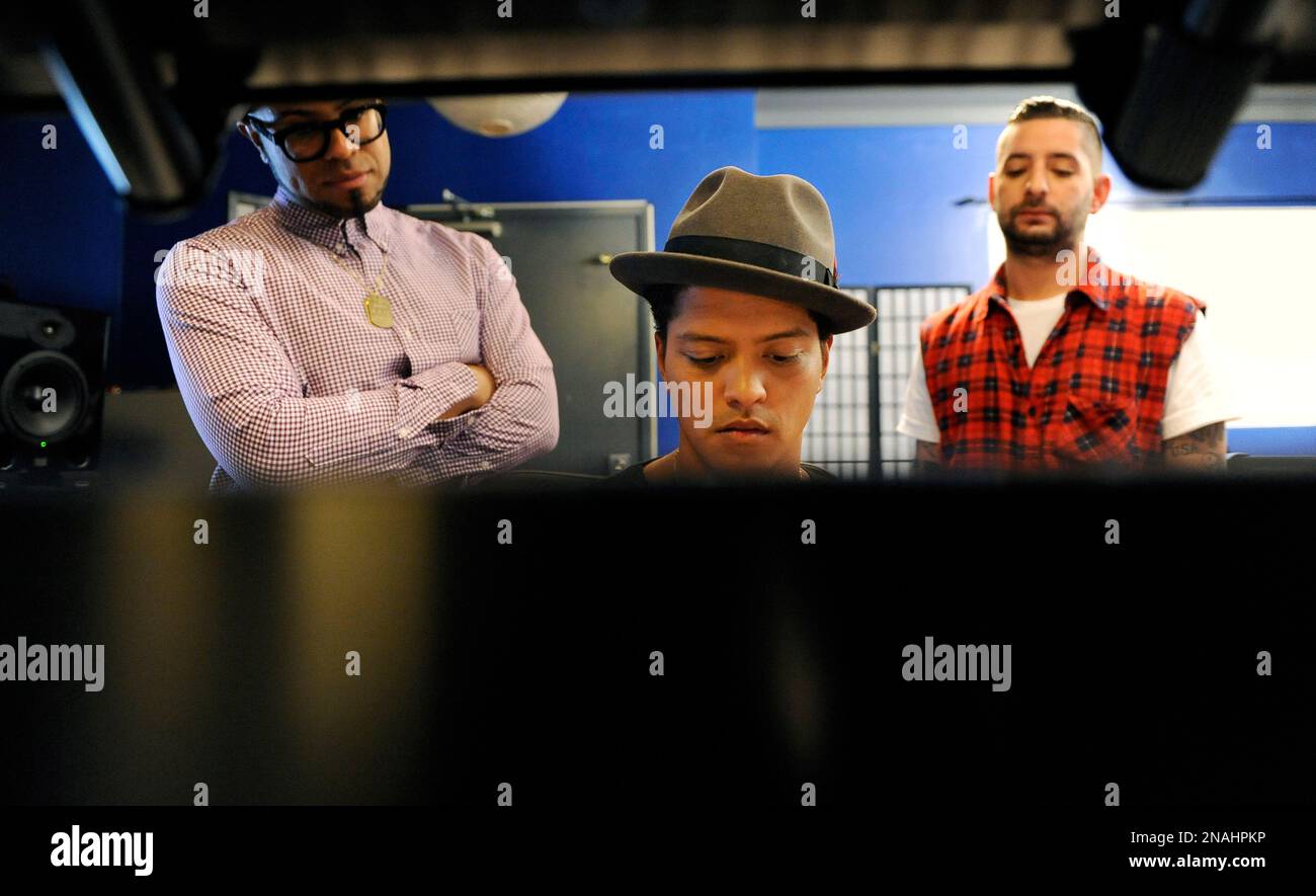 Philip Lawrence, left, and Ari Levine, right, listen as Bruno Mars ...