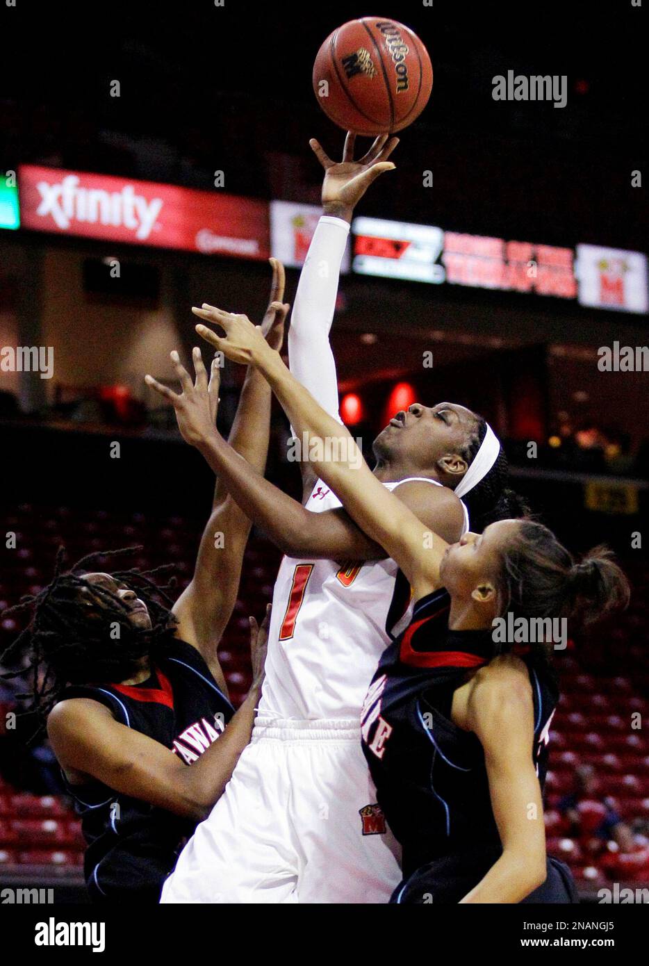 Maryland guard Laurin Mincy, center, goes up for a shot between ...