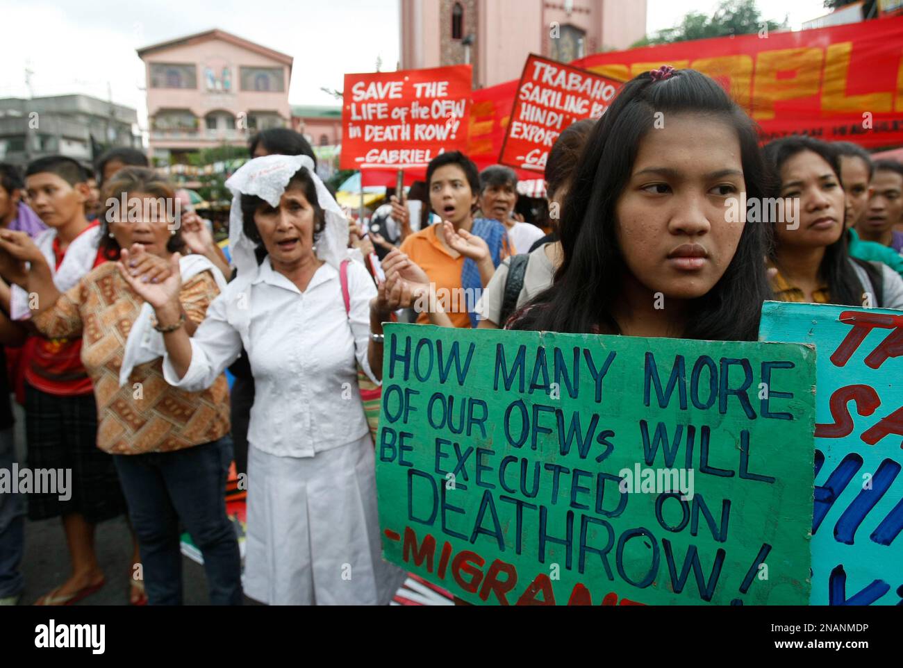 Protesters sing prayers during a mass outside a Catholic church in ...