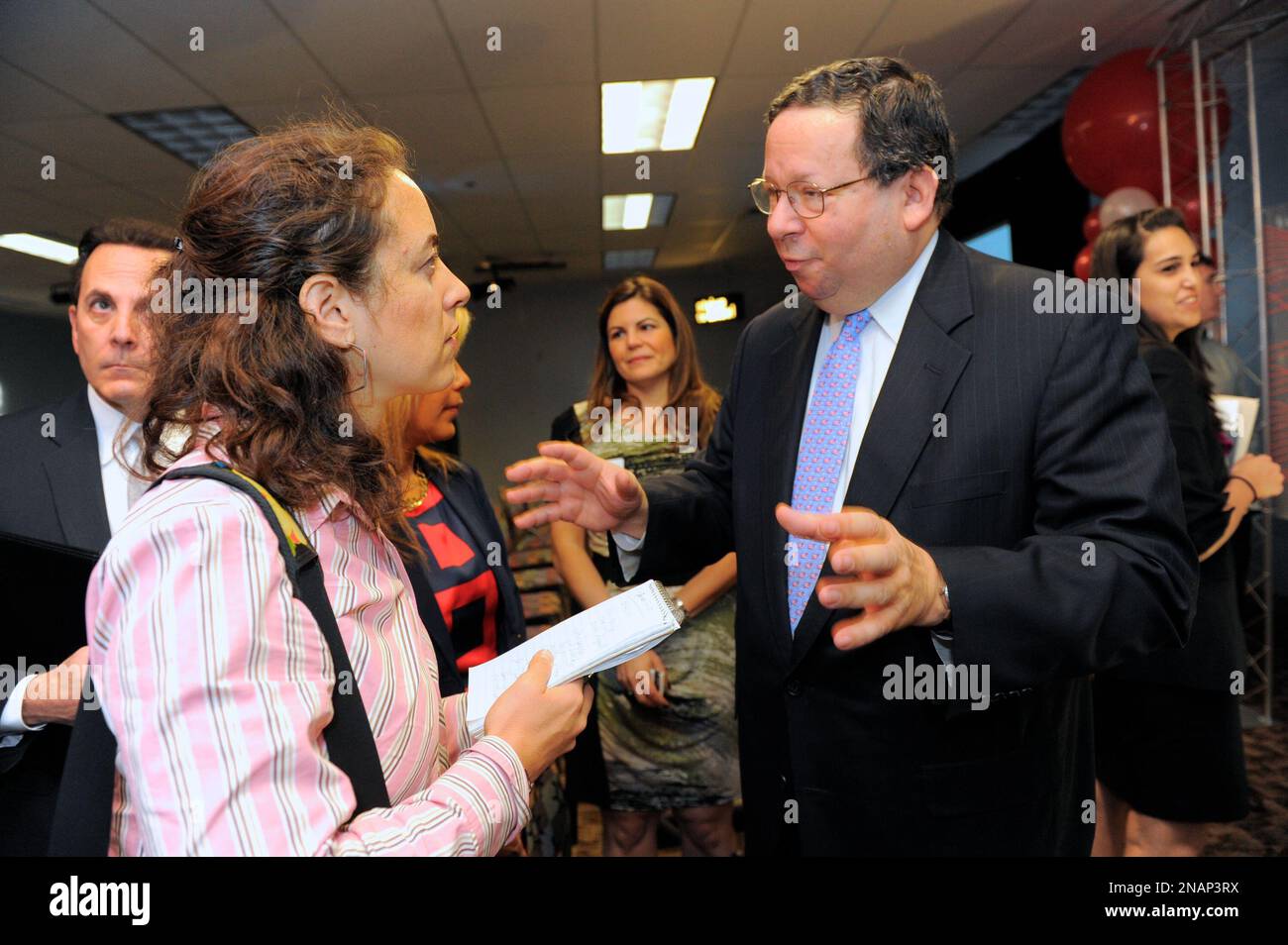 A reporter, left, interviews Comcast Corporation executive vice ...