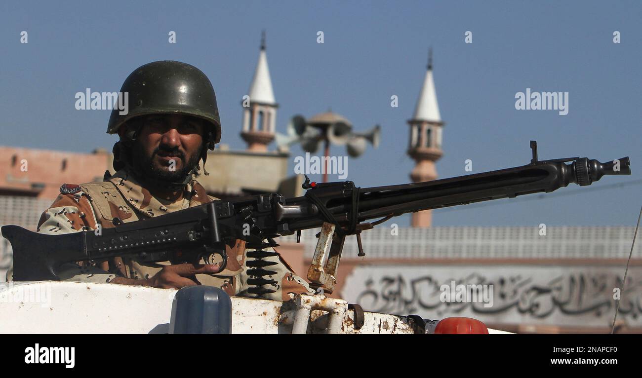 A Pakistani paramilitary soldier stands guards outside a mosque to ...