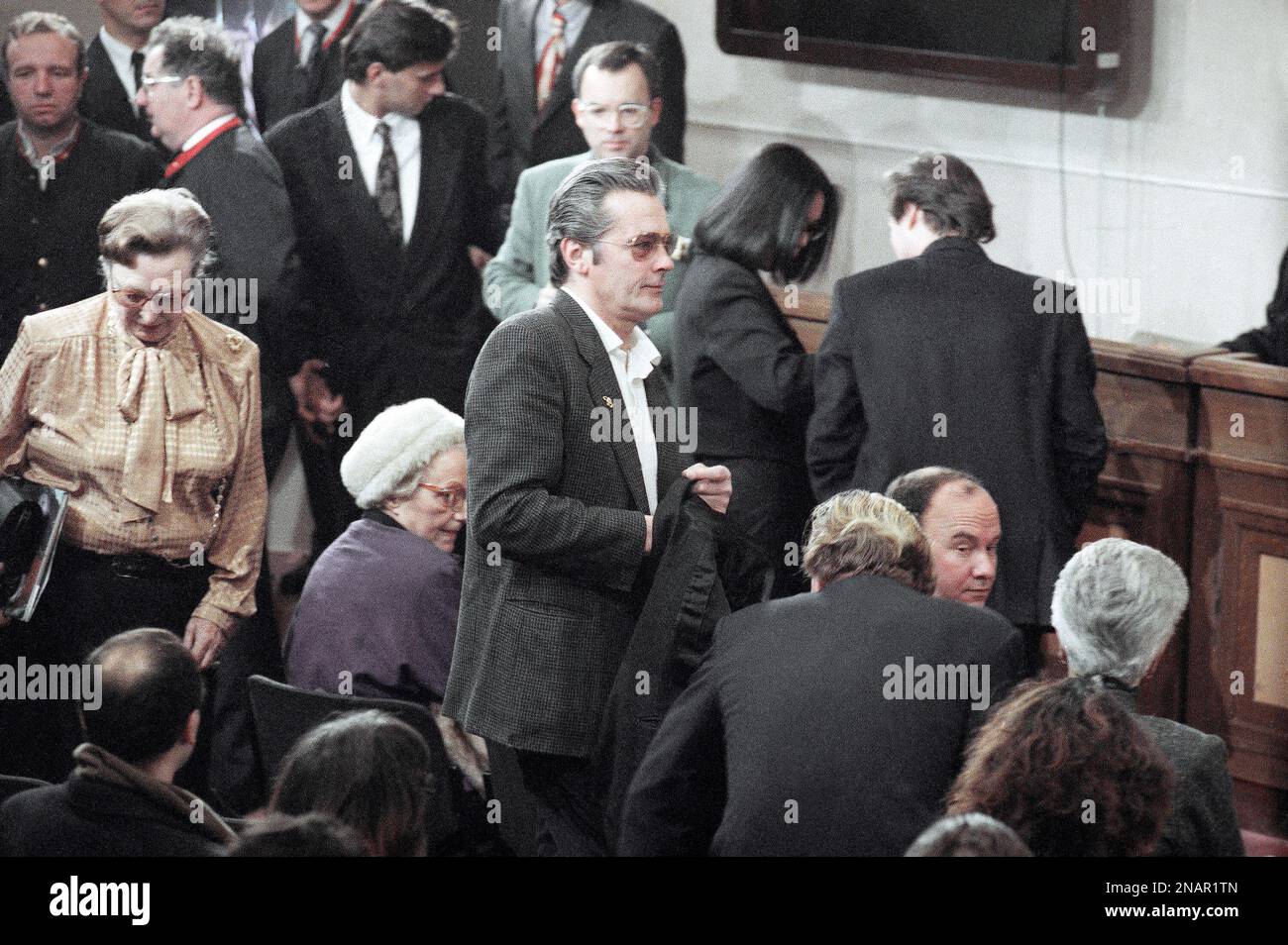 French actor Alain Delon, standing at center, is seen during an auction ...