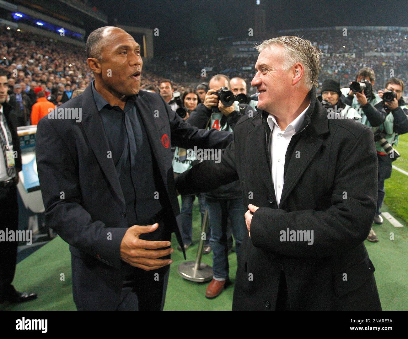 Marseille's coach Didier Deschamps, right, speaks with Paris Saint ...