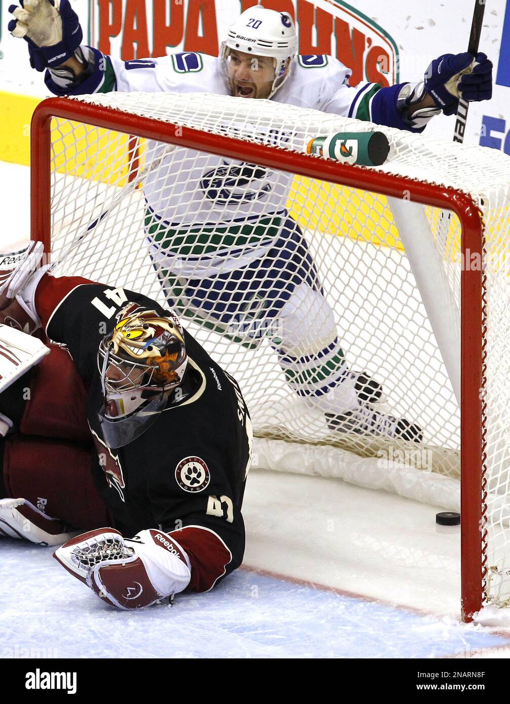 Vancouver Canucks' Christopher Higgins, top, celebrates a goal by ...
