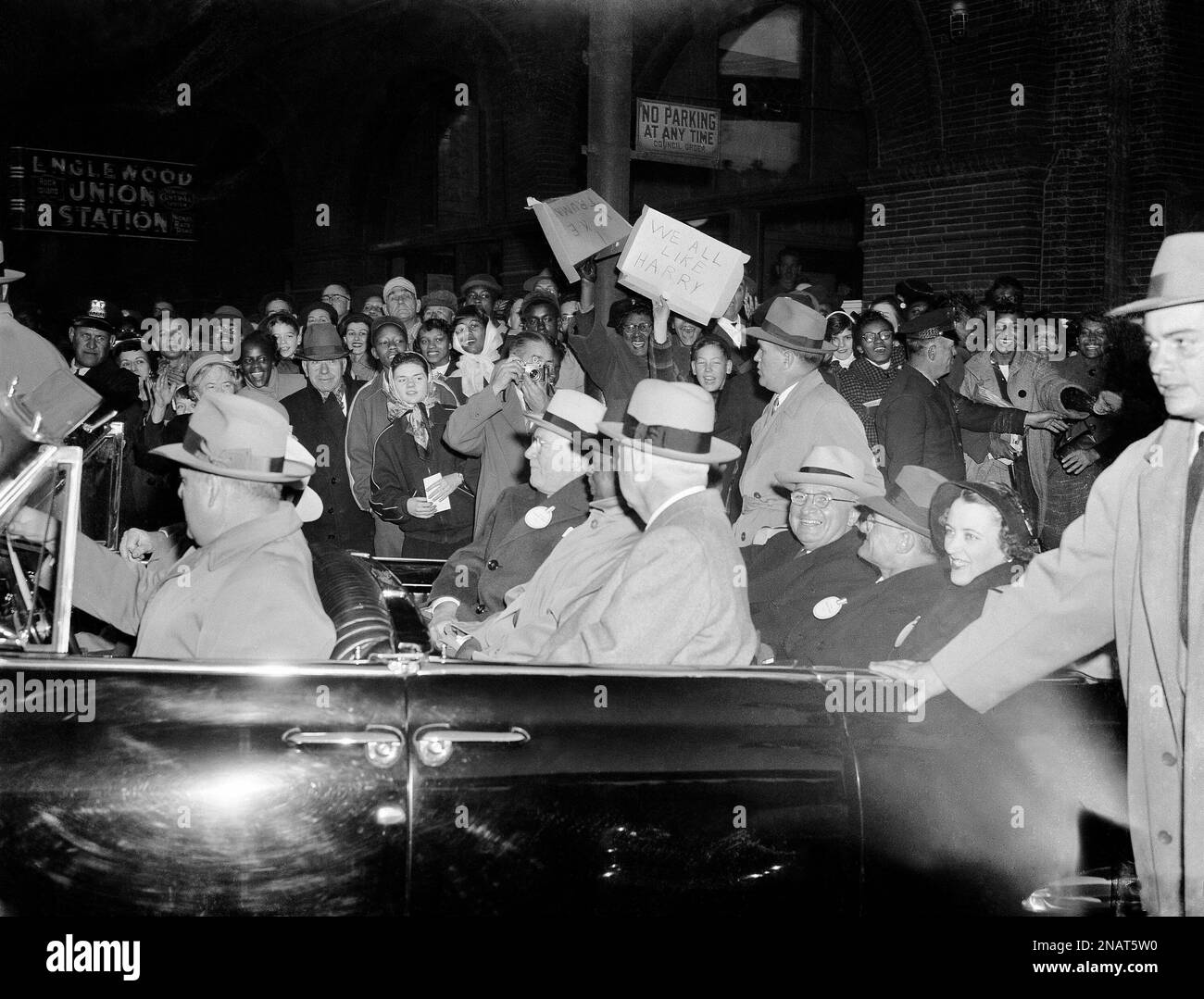 President Harry S. Truman (back seat, left) smiles broadly as his ...