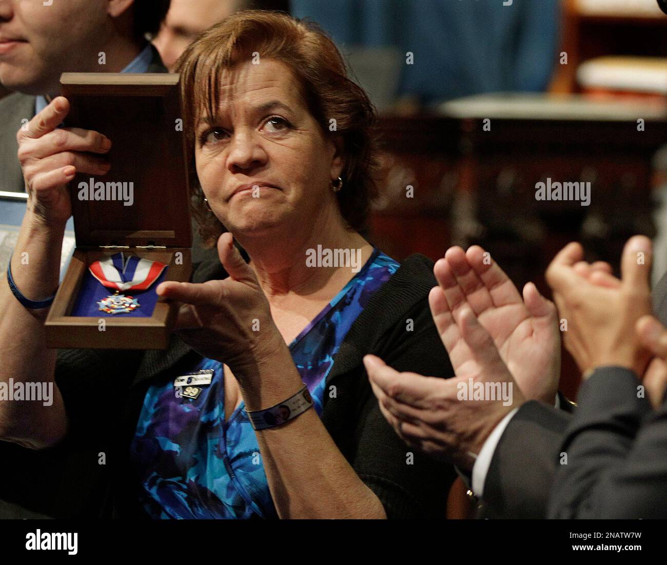 Desiree Maguire is applauded as she holds up the Trooper George L ...