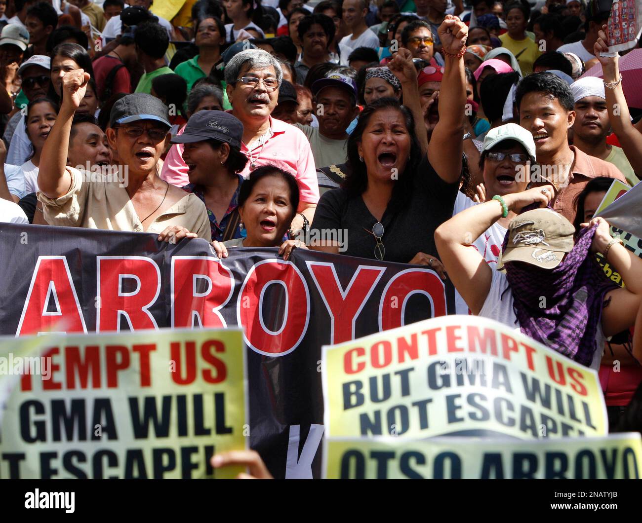 Hundreds of protesters shout slogans and display placards as they march ...