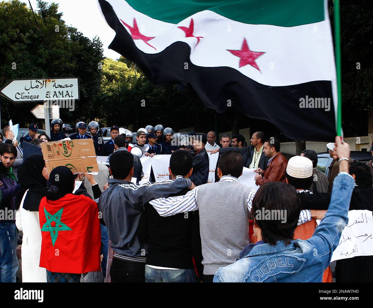 Police officer keep watch on protesters as Moroccans and Syrian ...