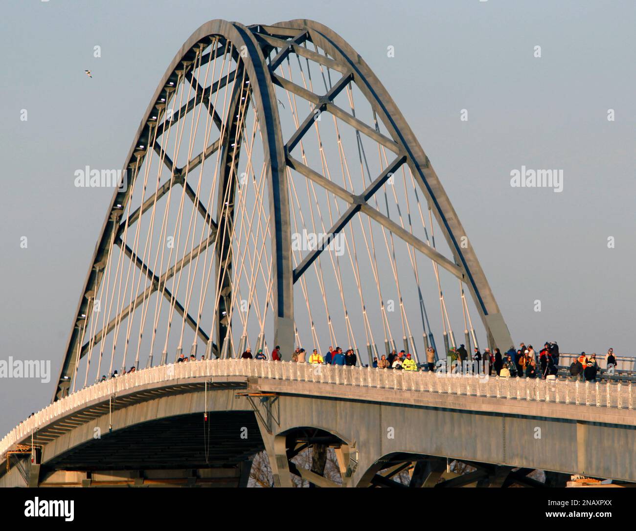 Pedestrians walk across the Lake Champlain Bridge after a dedication ...