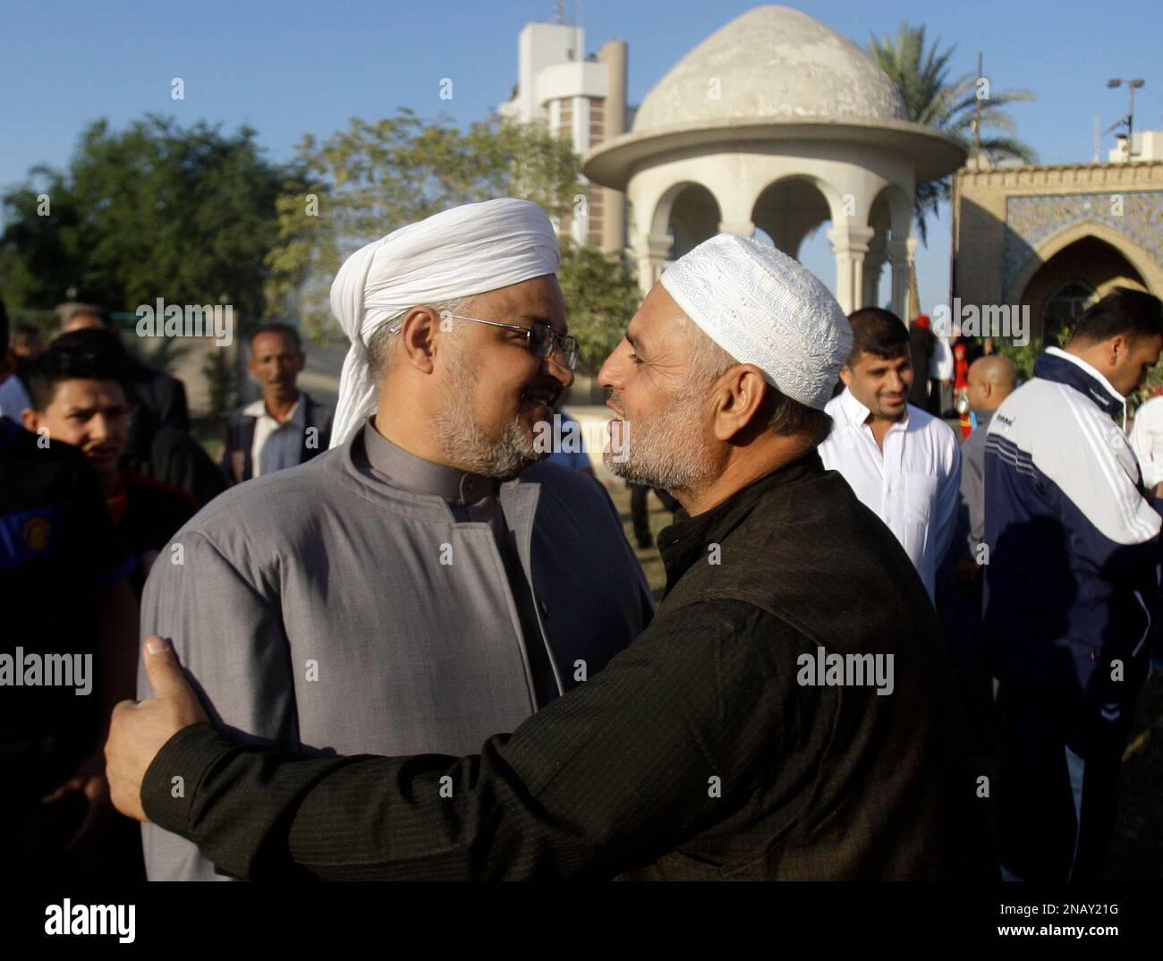 Iraqi Muslims exchange greetings after Eid prayers outside the 14th ...