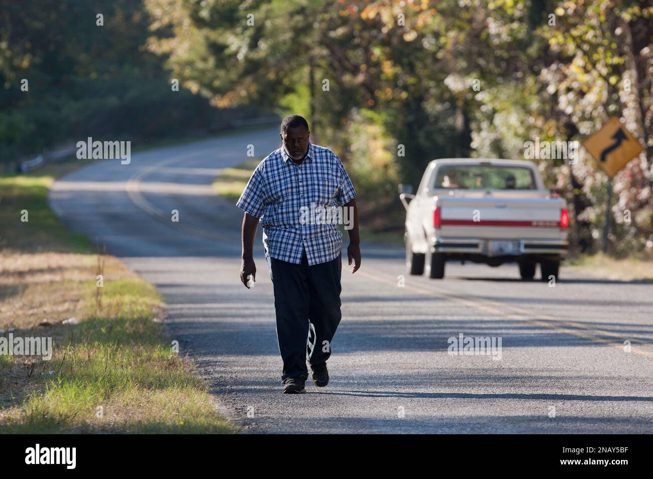In this Wednesday, Oct. 26, 2011 photo, James Ware walks down the road ...