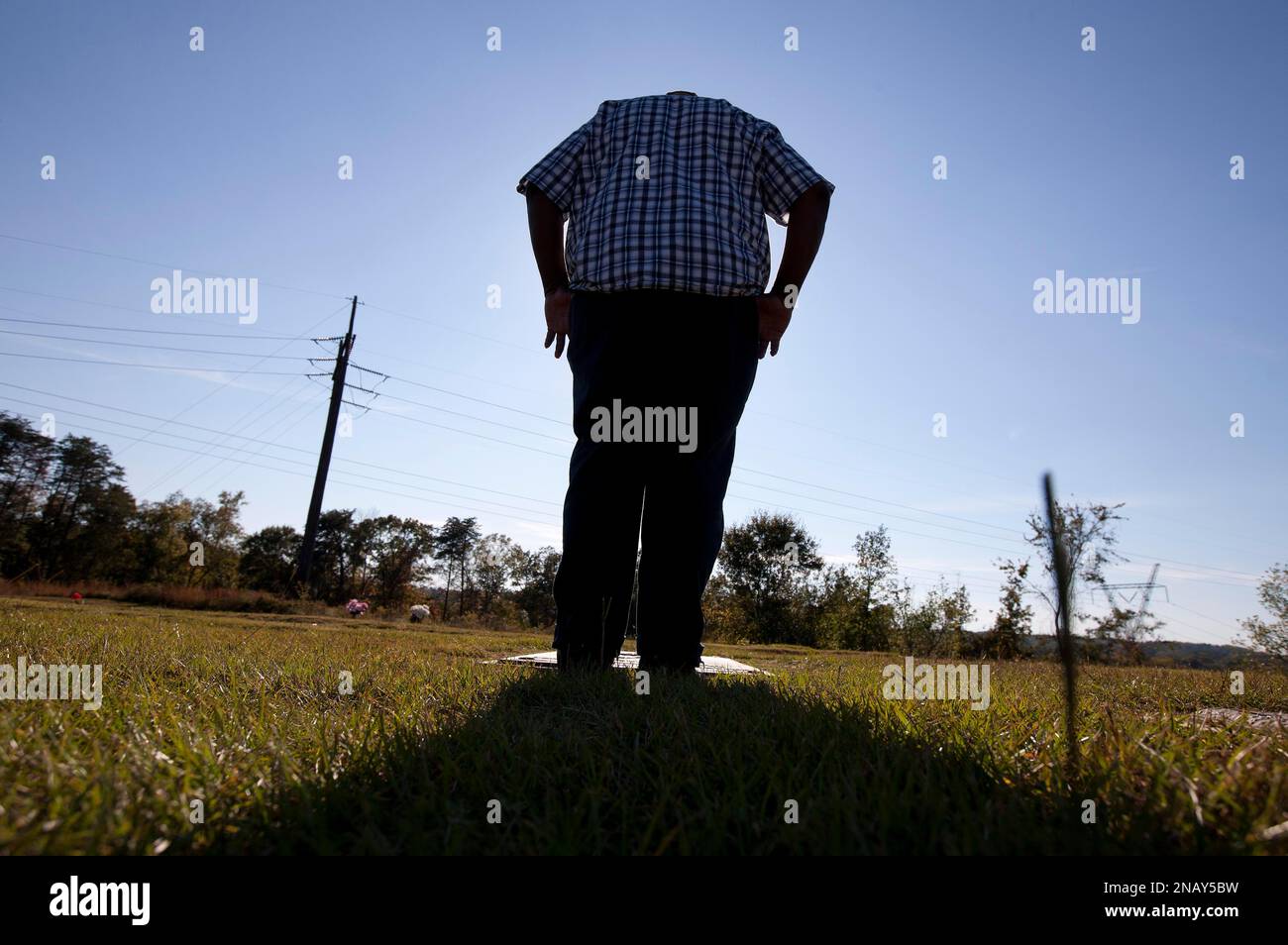 In this Wednesday, Oct. 26, 2011 photo, James Ware stands over the ...