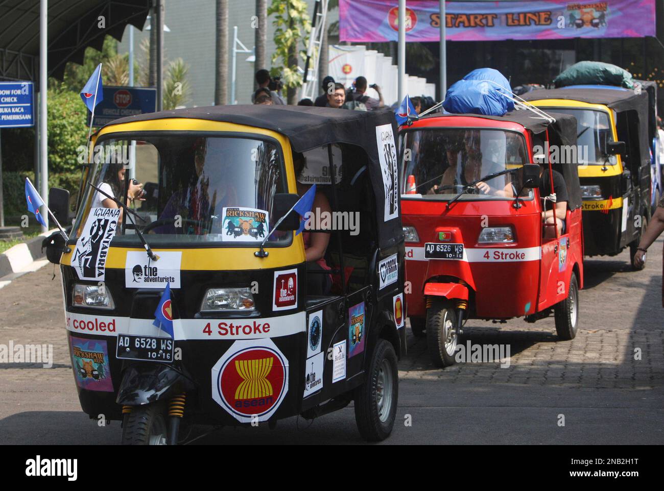 Participants drive rickshaws at the start of the "ASEAN Rickshaw Run ...
