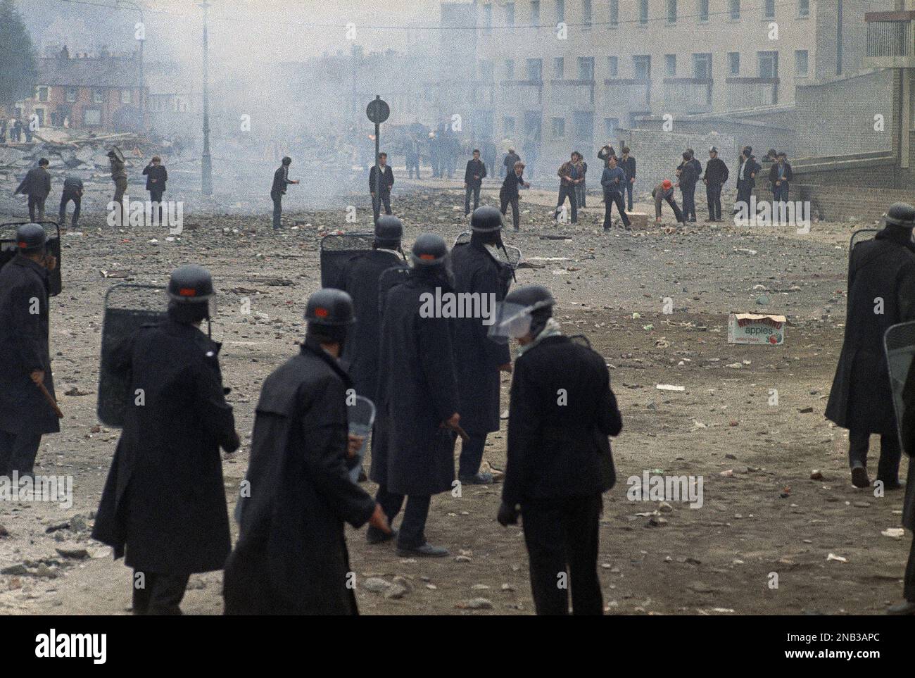 Riot police wearing helmets, carrying shields and supported by armored ...
