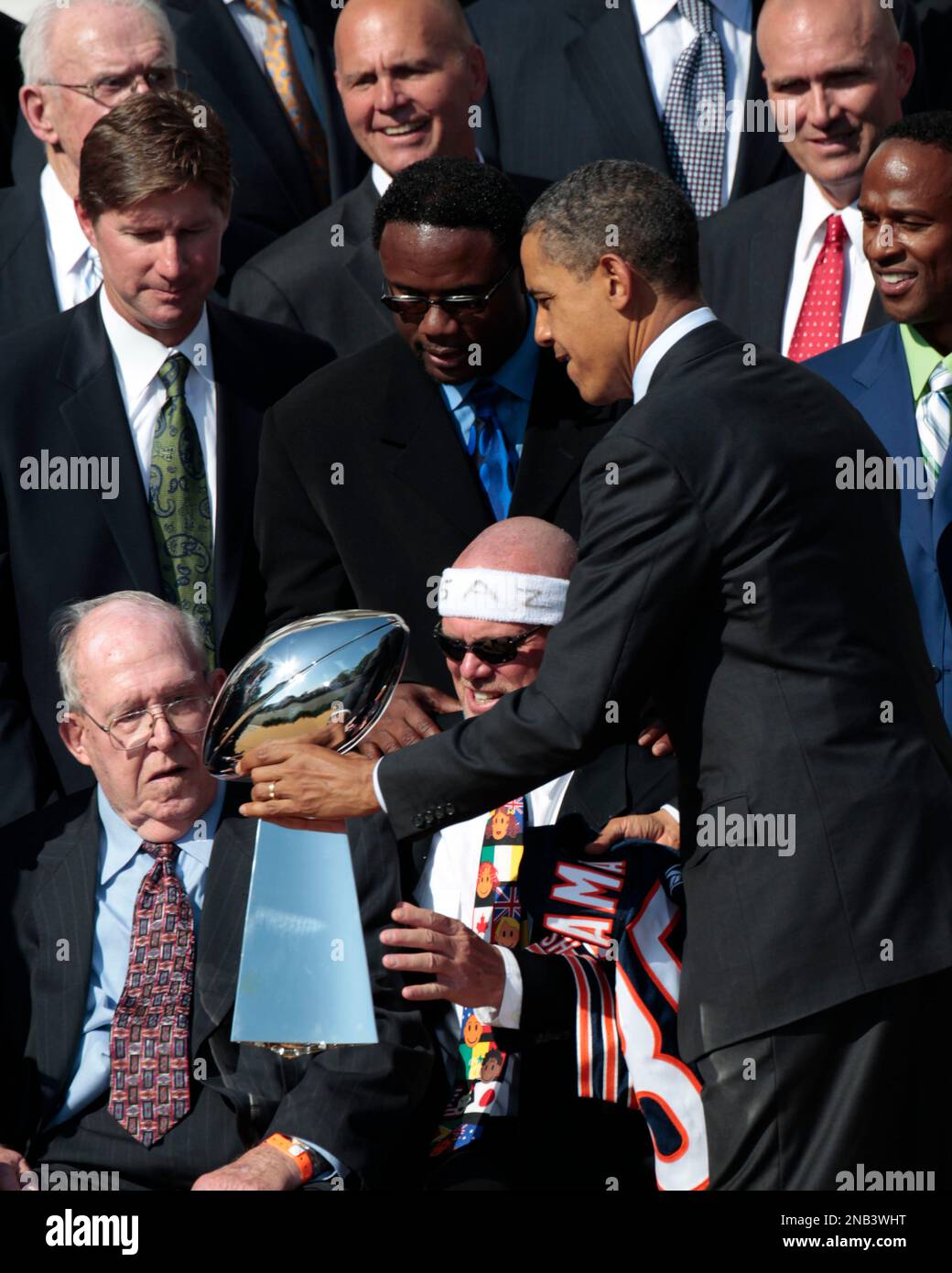 President Barack Obama, right, passes the Super Bowl Trophy to ...