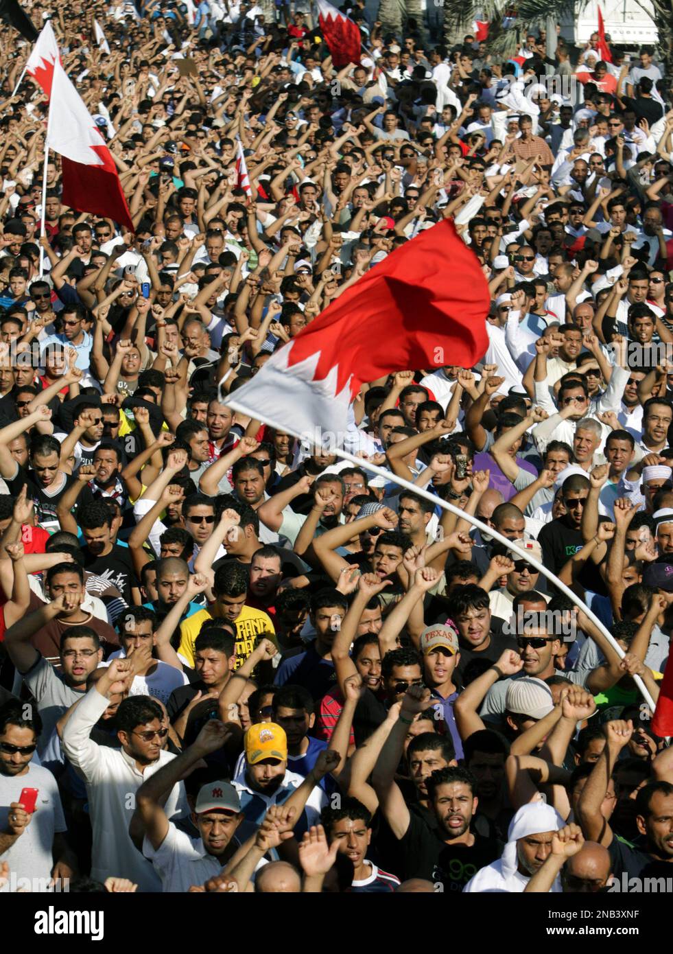 Tens of thousands of Bahrainis shout anti-government slogans and wave ...
