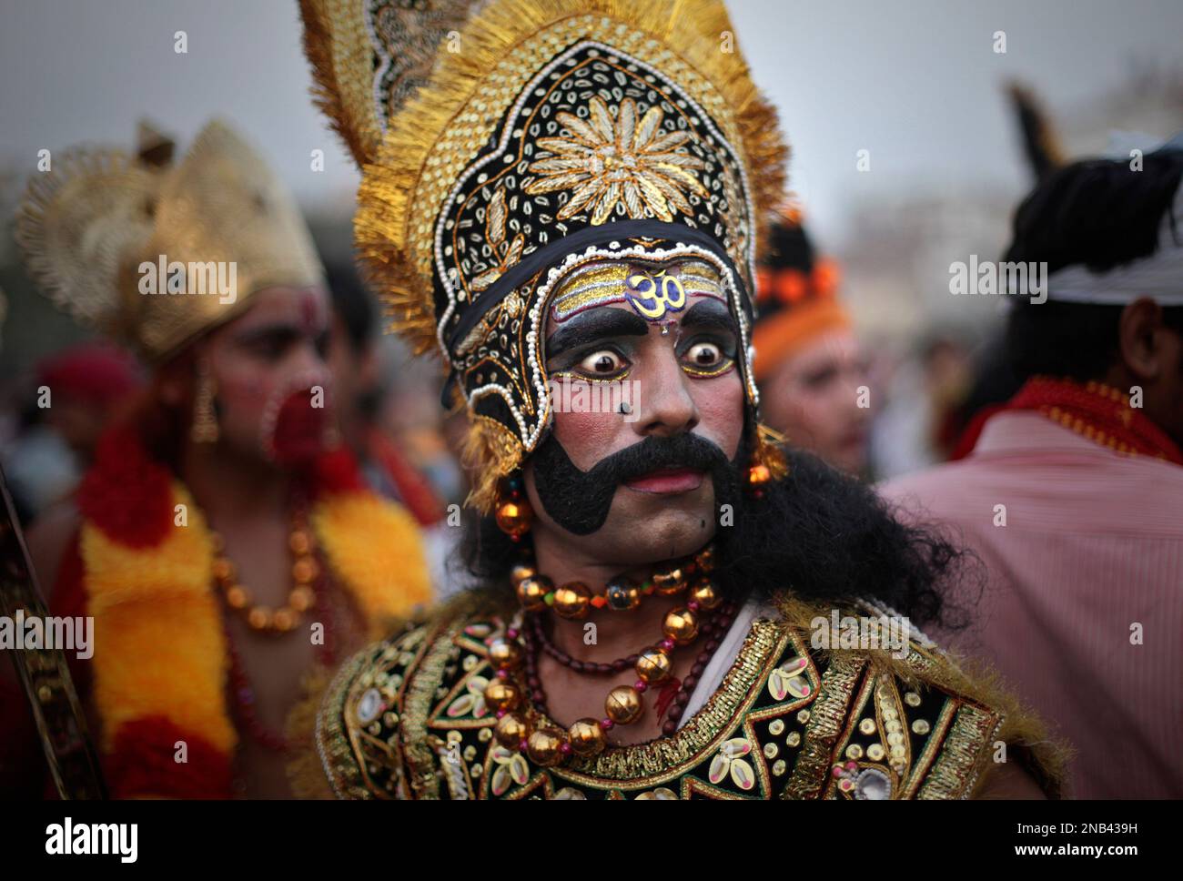 An Indian Hindu man dressed as demon king Ravana looks on at a venue of ...