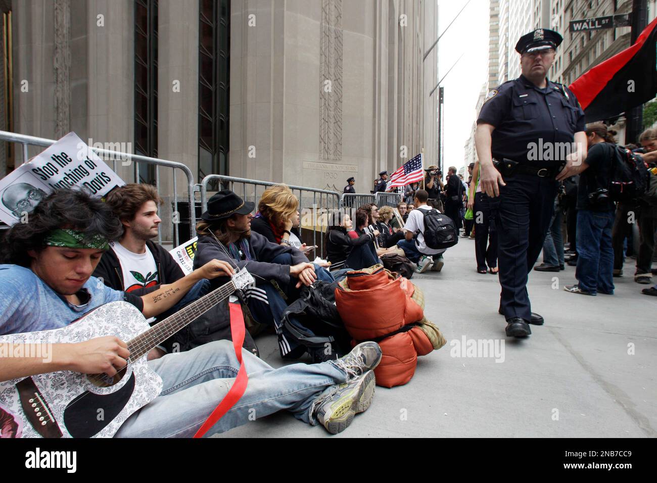 Demonstrators gather in front of a police barricade to call for the ...