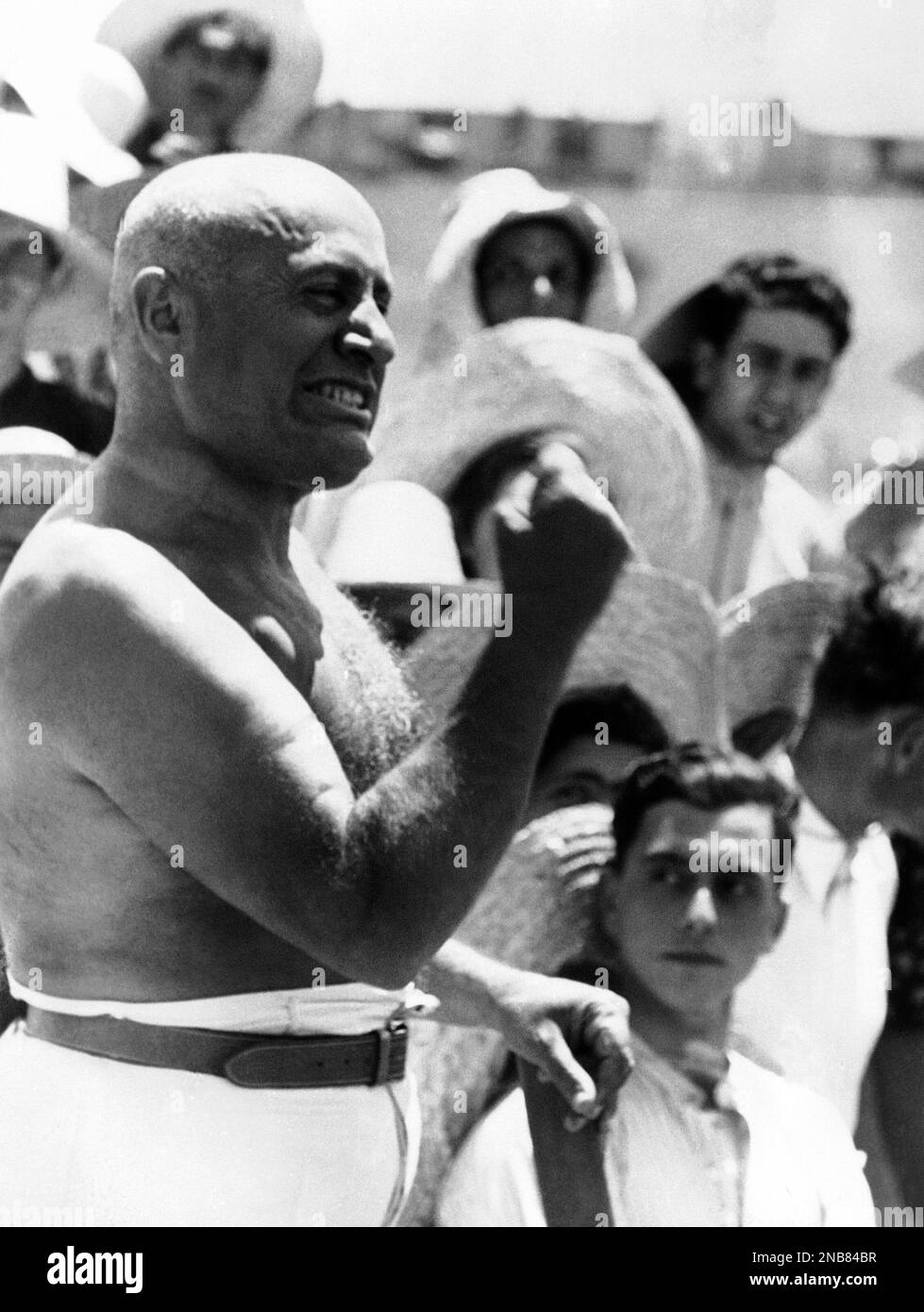 Italian dictator Benito Mussolini, stripped to the waist, with right ...