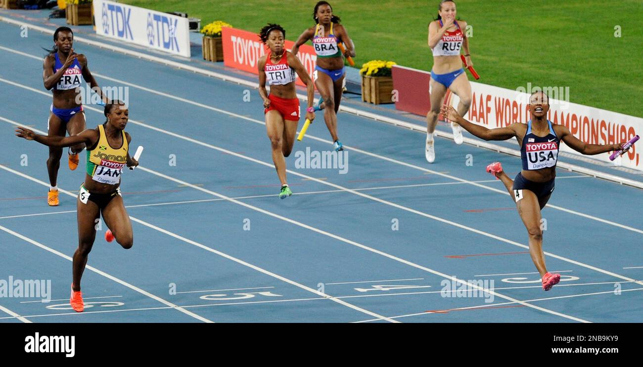 USA's Carmelita Jeter, right, crosses the finish line to win ahead of ...