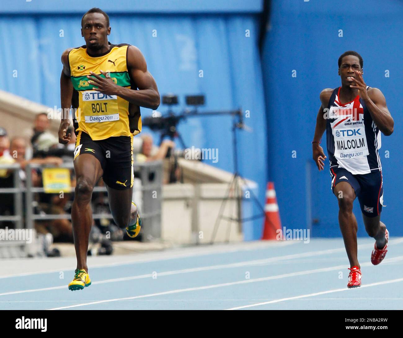 Jamaica's Usain Bolt, left, runs to the finish line to place first ...