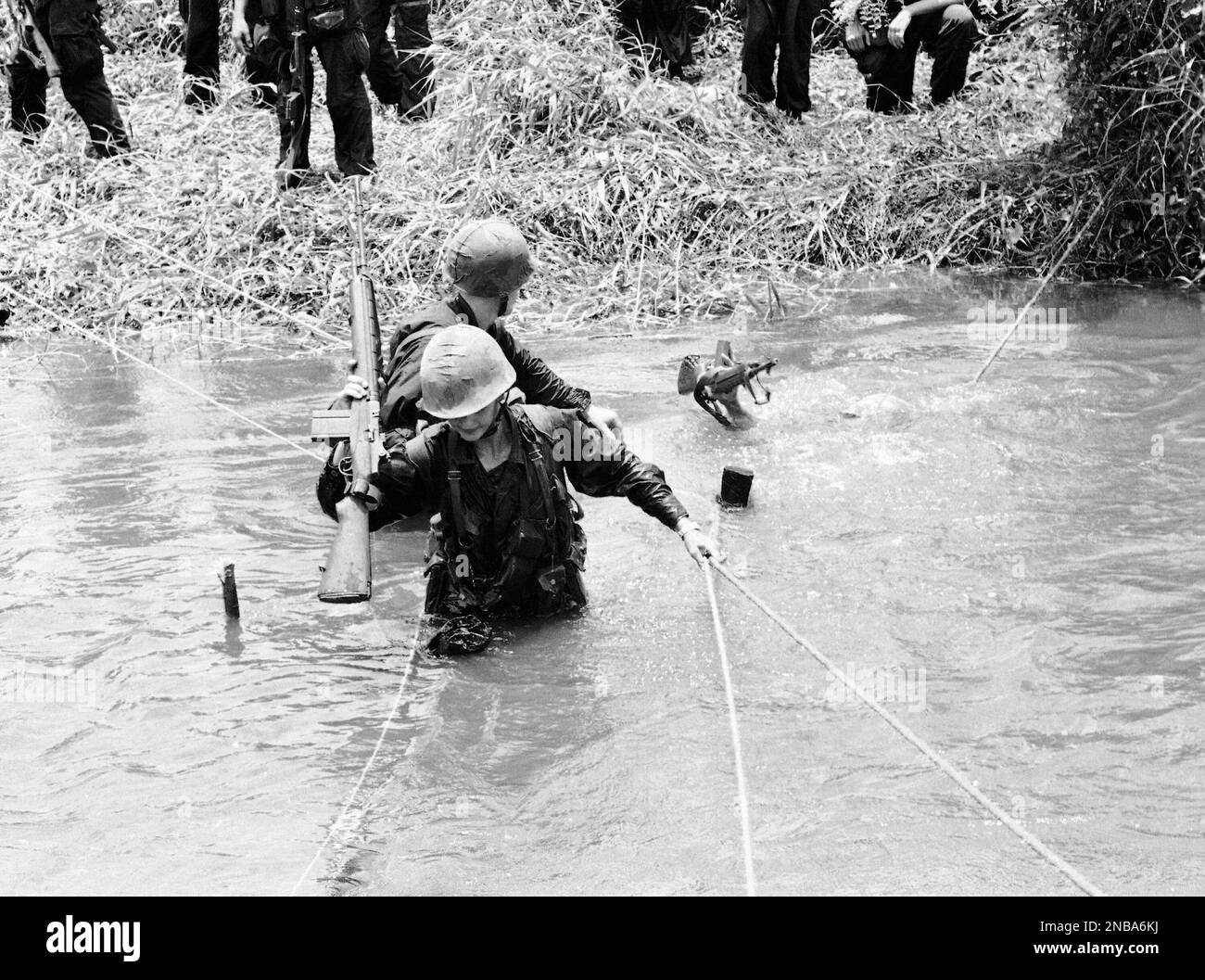 A Marine of the First Battalion, 26th Marines holds his rifle out of ...