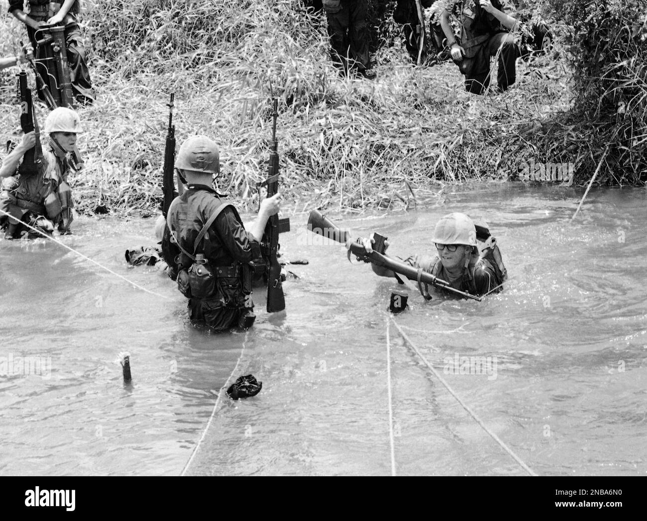 A Marine of the First Battalion, 26th Marines holds his rifle out of ...