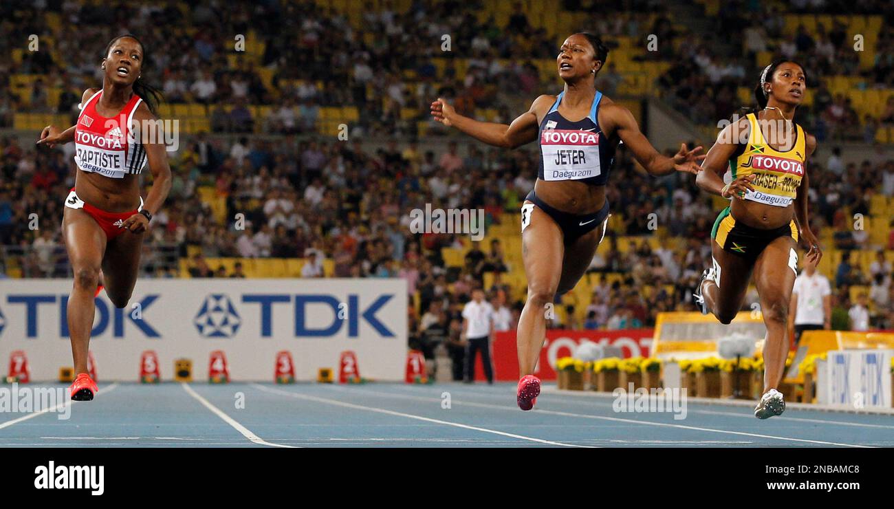 USA's Carmelita Jeter, center, crosses the finish line ahead of ...