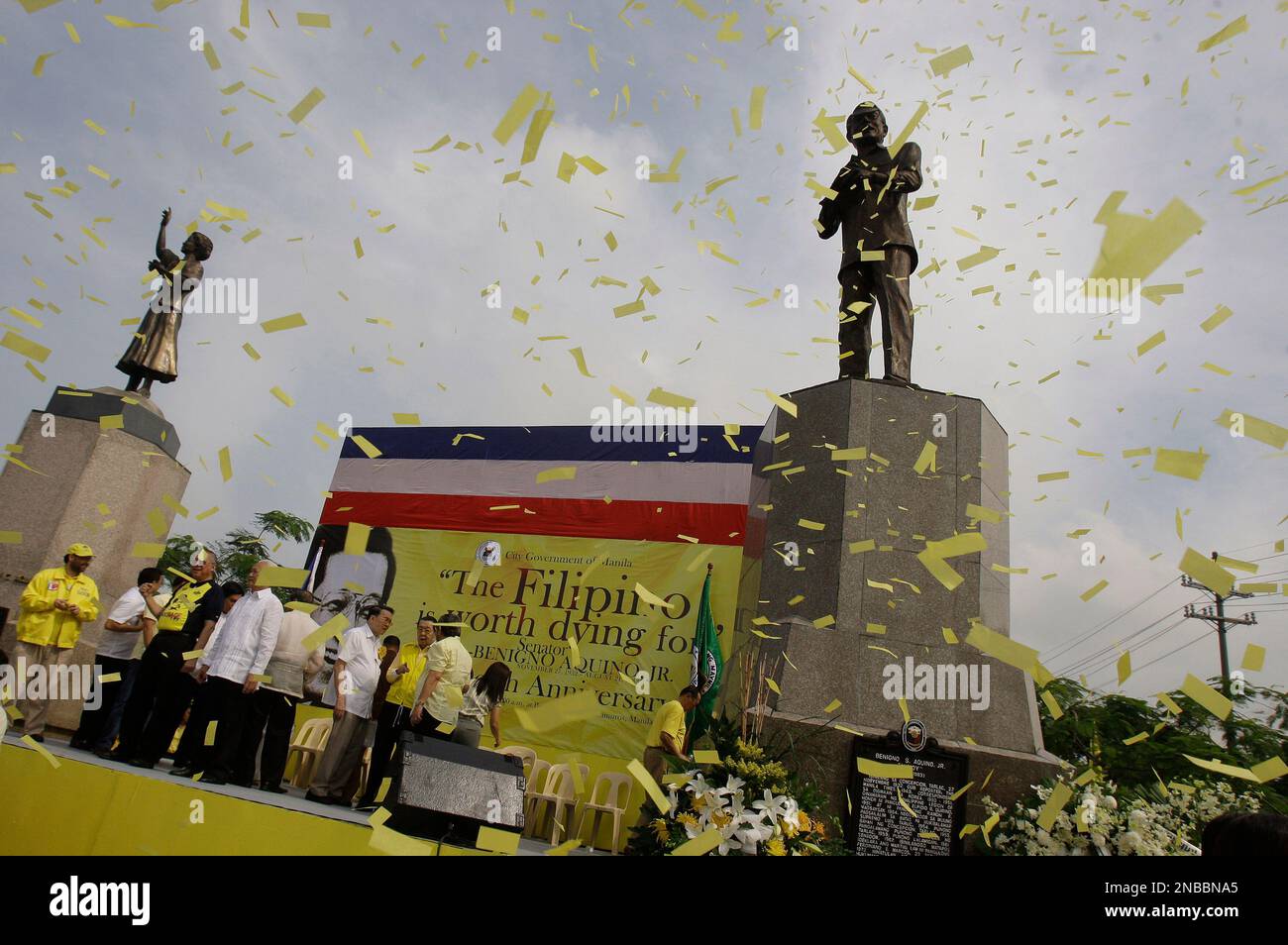 Yellow confetti flies around a statue of the late senator Benigno ...
