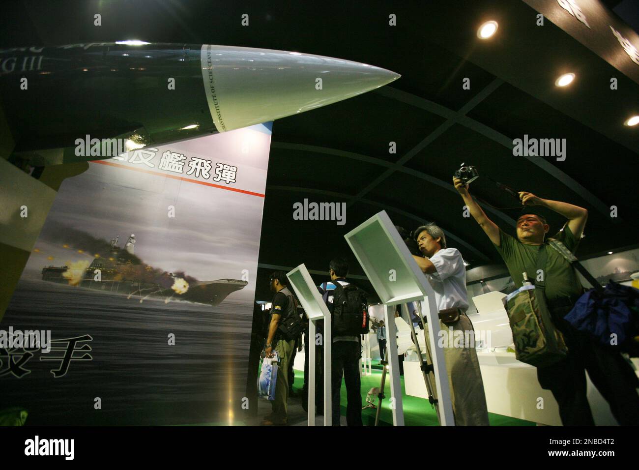 Visitors look at Taiwan's indigenous Hsiung Feng III missile propped ...