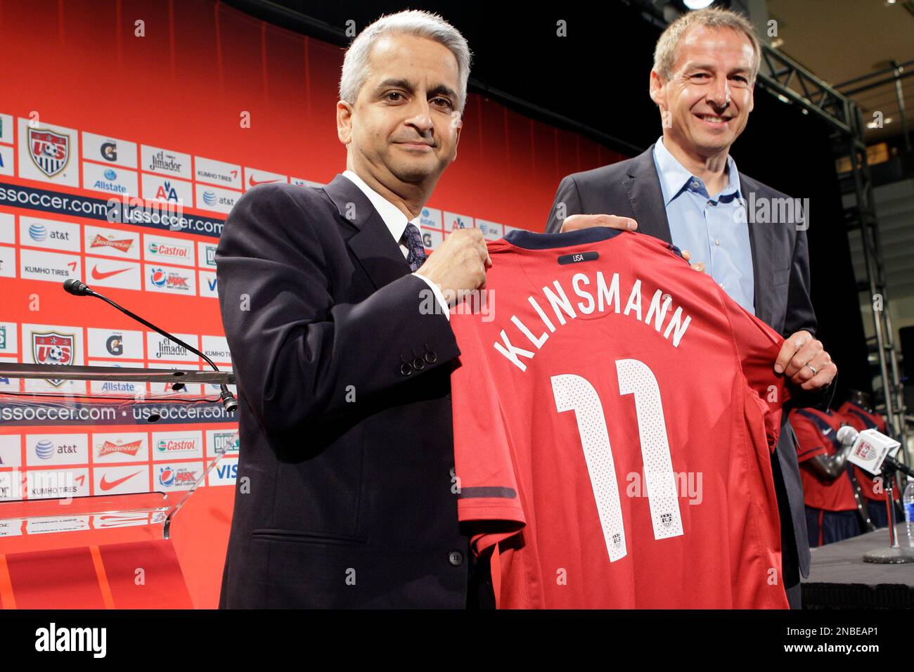 Juergen Klinsmann, of Germany, right, smiles after being introduced as ...